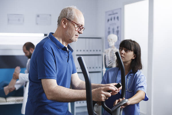 Old man receives physiotherapy at clinic by Dragos Condrea | 500px