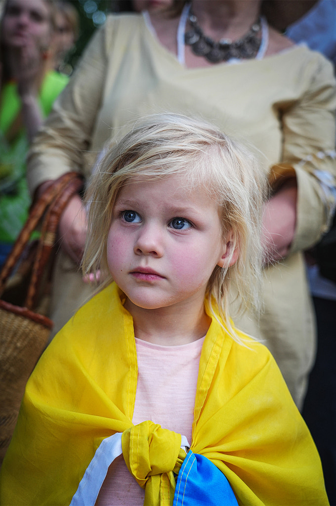 Young Girl Wrapped in Ukrainian Flag Looking Up | people photo by ...