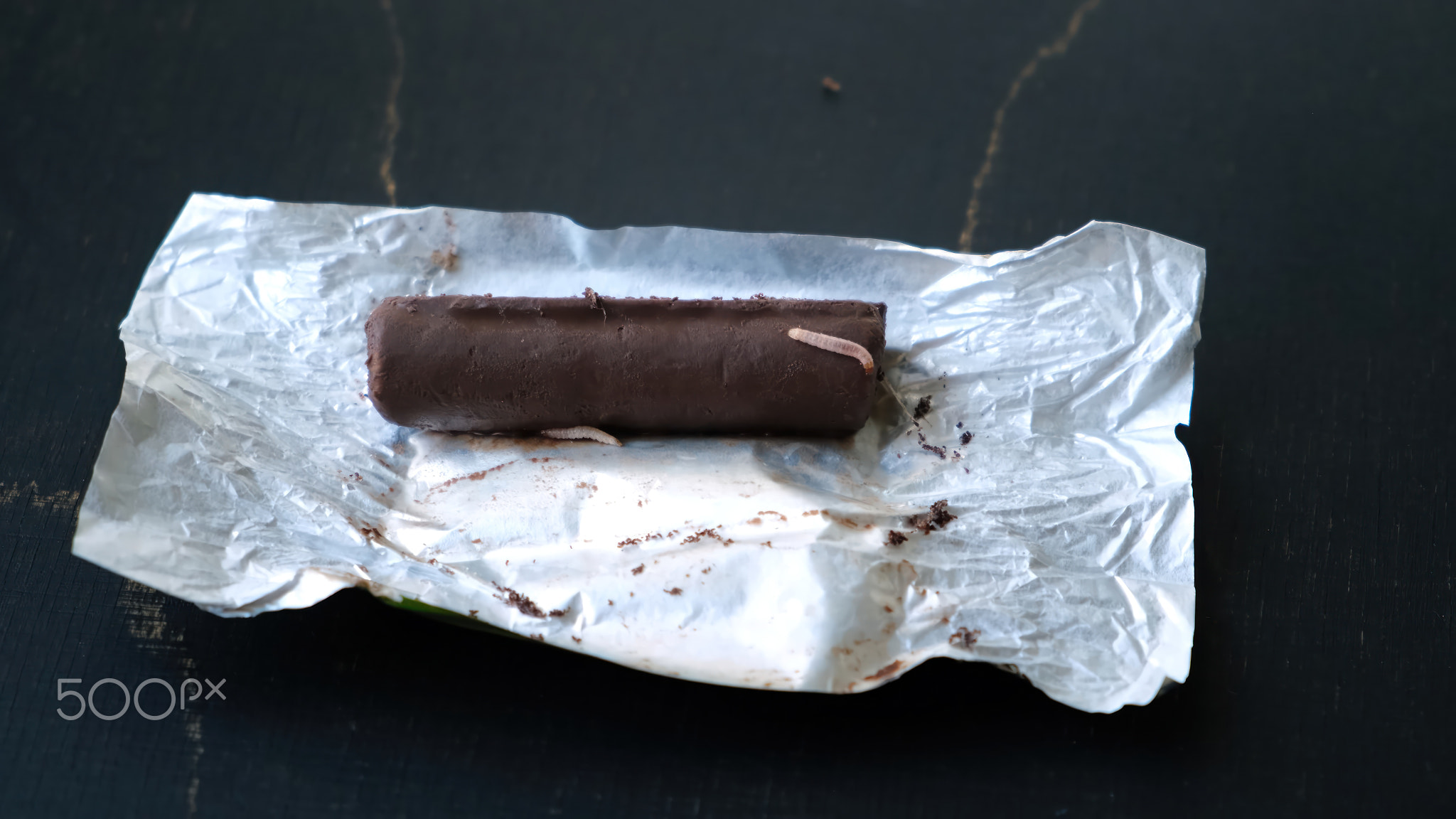 Worms crawls on chocolate candy. Crawling larvae and eggs laid on food ...