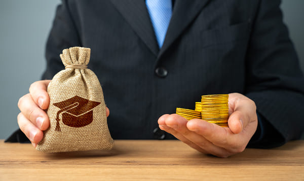 A man with a bag of knowledge and money coins. The concept of paid ...