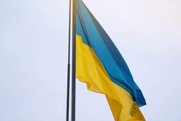 Ukraine flag, national symbol fluttering in blue sky. Large yellow blue ...