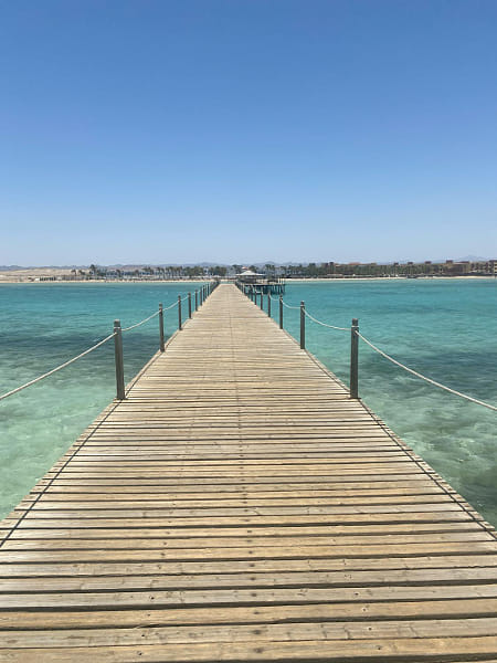 View of pier over sea against clear blue sky by Wens Sky | 500px
