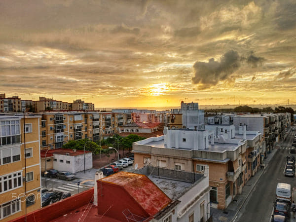 Cityscape at Sunset with Residential Buildings and Cloudy Sky | city ...