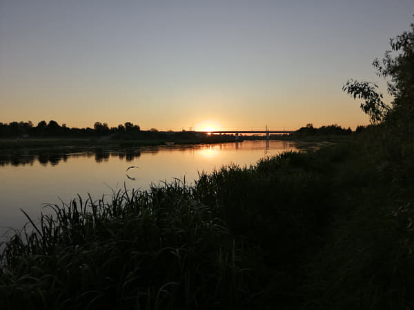Scenic view of lake against clear sky during sunset by Andrei Bulatov ...