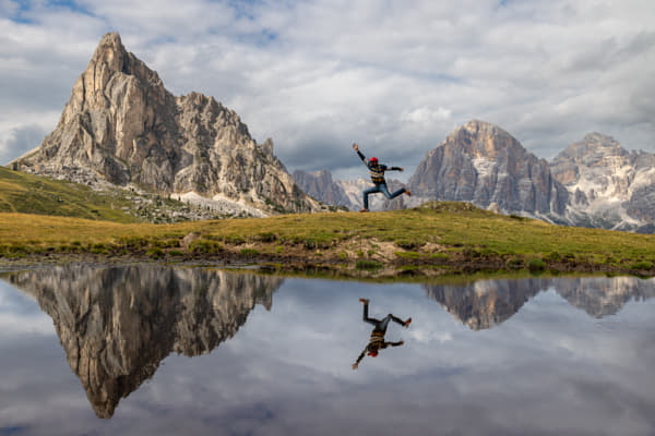 Man jumping over lake against mountains by Abhi Fotografie | 500px
