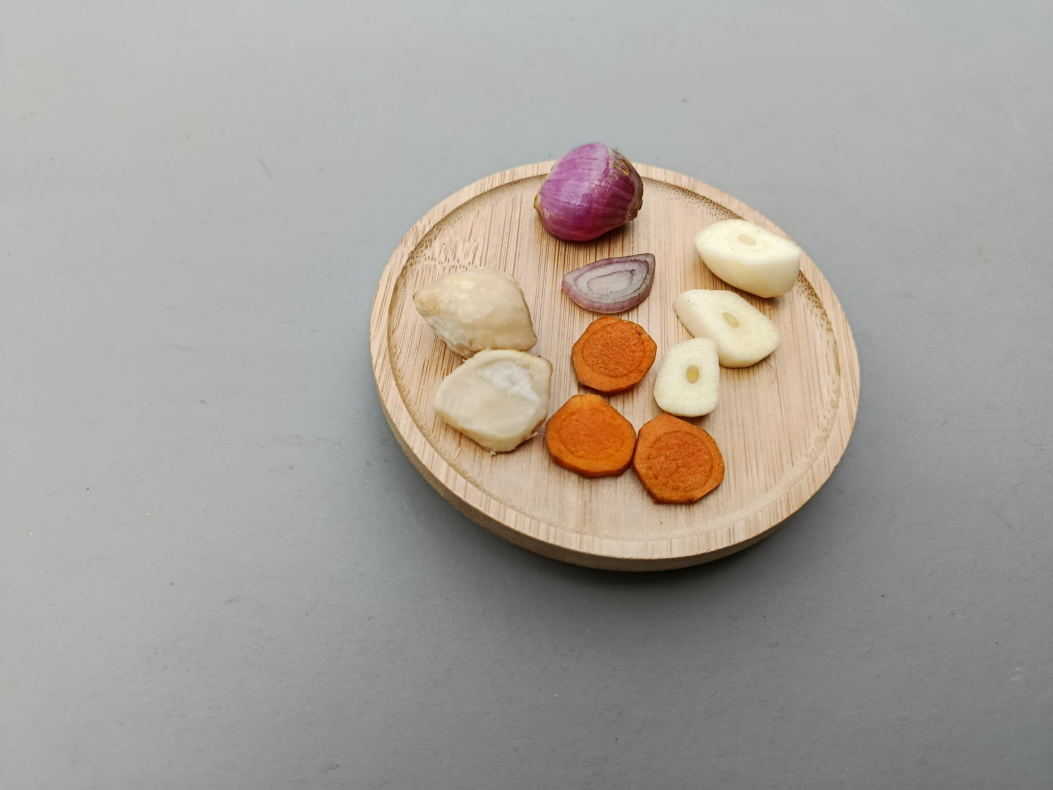 Fresh Shallot, Garlic, Turmeric, and Candlenut on Wooden Plate by ...