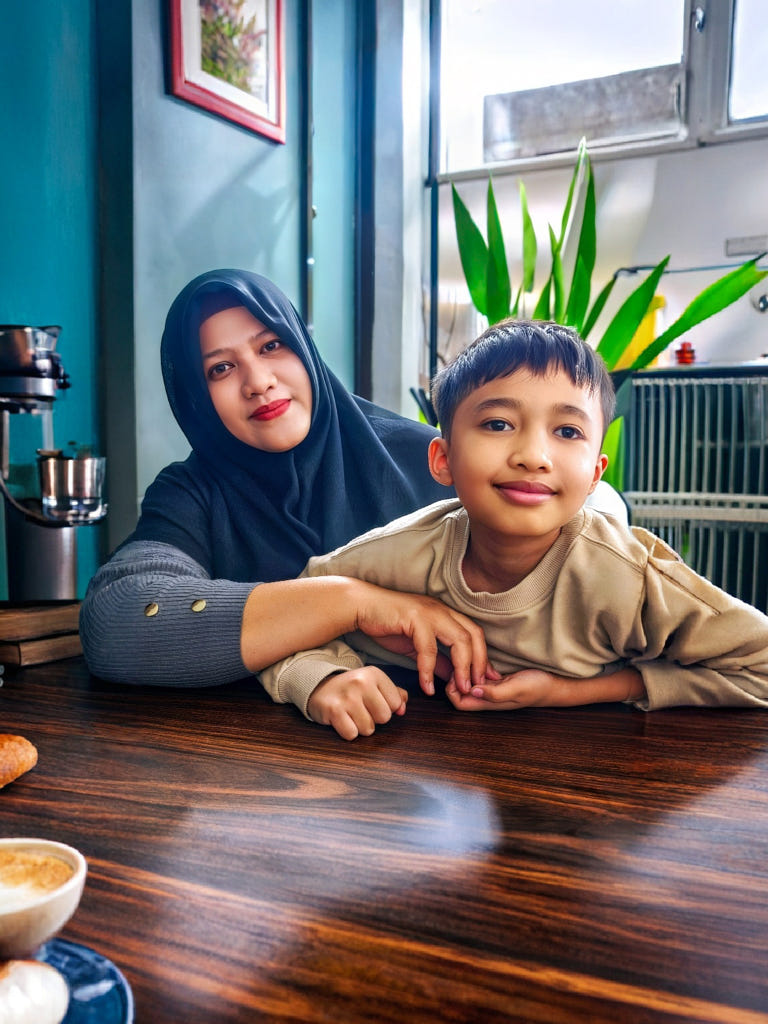 Mother and Child Share Moment of Affection and Comfort in Cozy Setting | people photo by Ilham ...