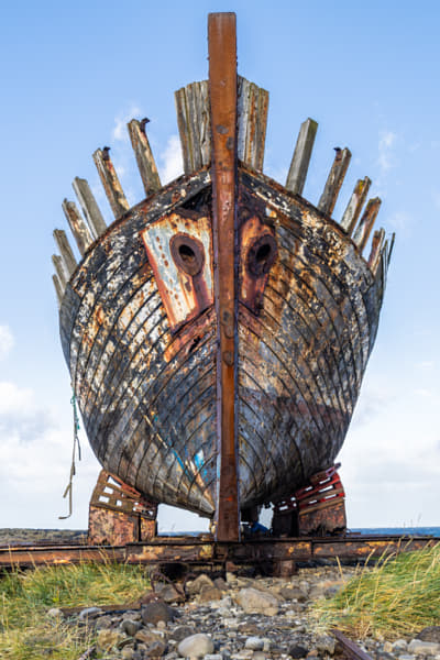 Weathered Shipwreck Standing on Shoreline Symbolizing Resilience and ...