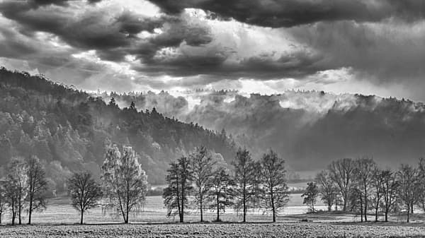 Monochromatic Landscape Under Dramatic Skies Portraying Somber Beauty ...