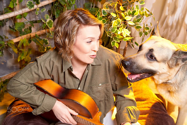 Woman and Dog Share a Musical Moment | people photo by Elena ...