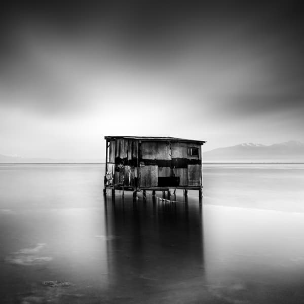 Dilapidated Shack on Still Water Symbolizing Solitude and Desolation ...