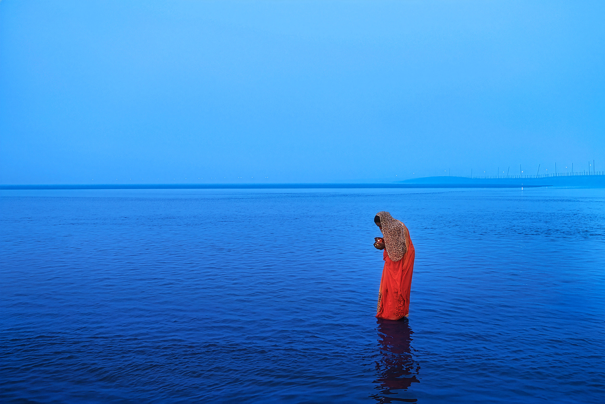 Figure Stands in Vast Water Evoking Solitude and Contemplation | people ...
