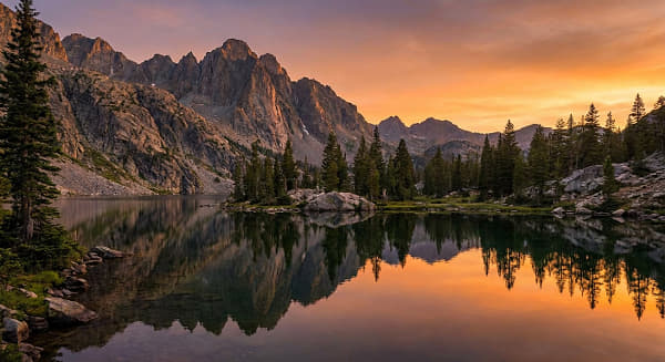 Serene Mountain Landscape with Pine Forest and Calm Water by John ...