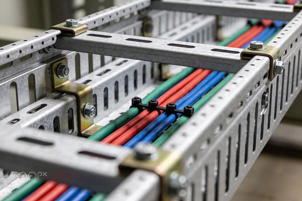Organized electrical cables neatly routed through a perforated metal ...