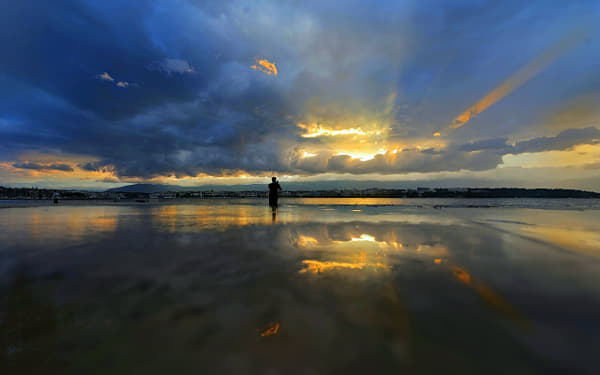 Lone Figure Contemplating Vast Horizon at Sunset Evoking Solitude ...