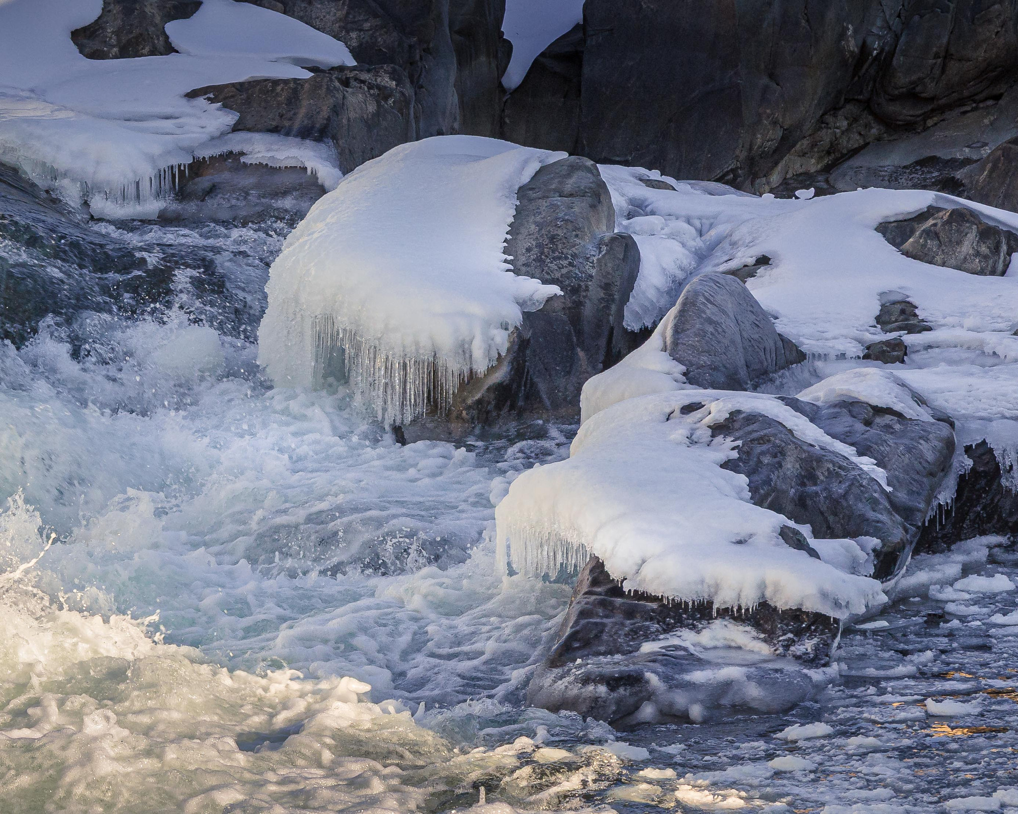 Icy River Flows Through Rocks Portraying Persistence and Natural Force ...