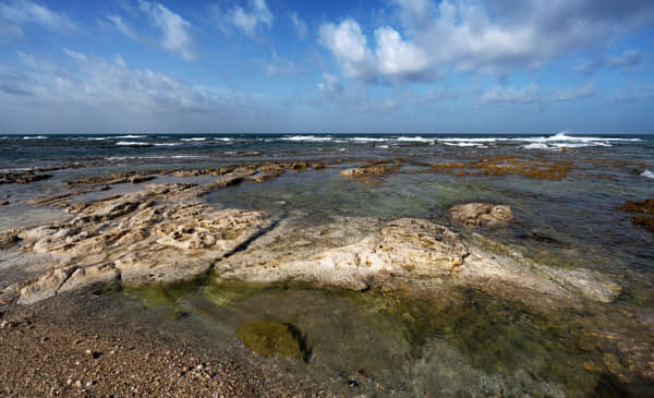 Rocky Coastline Under Blue Sky Evoking Serenity and Natural Beauty ...