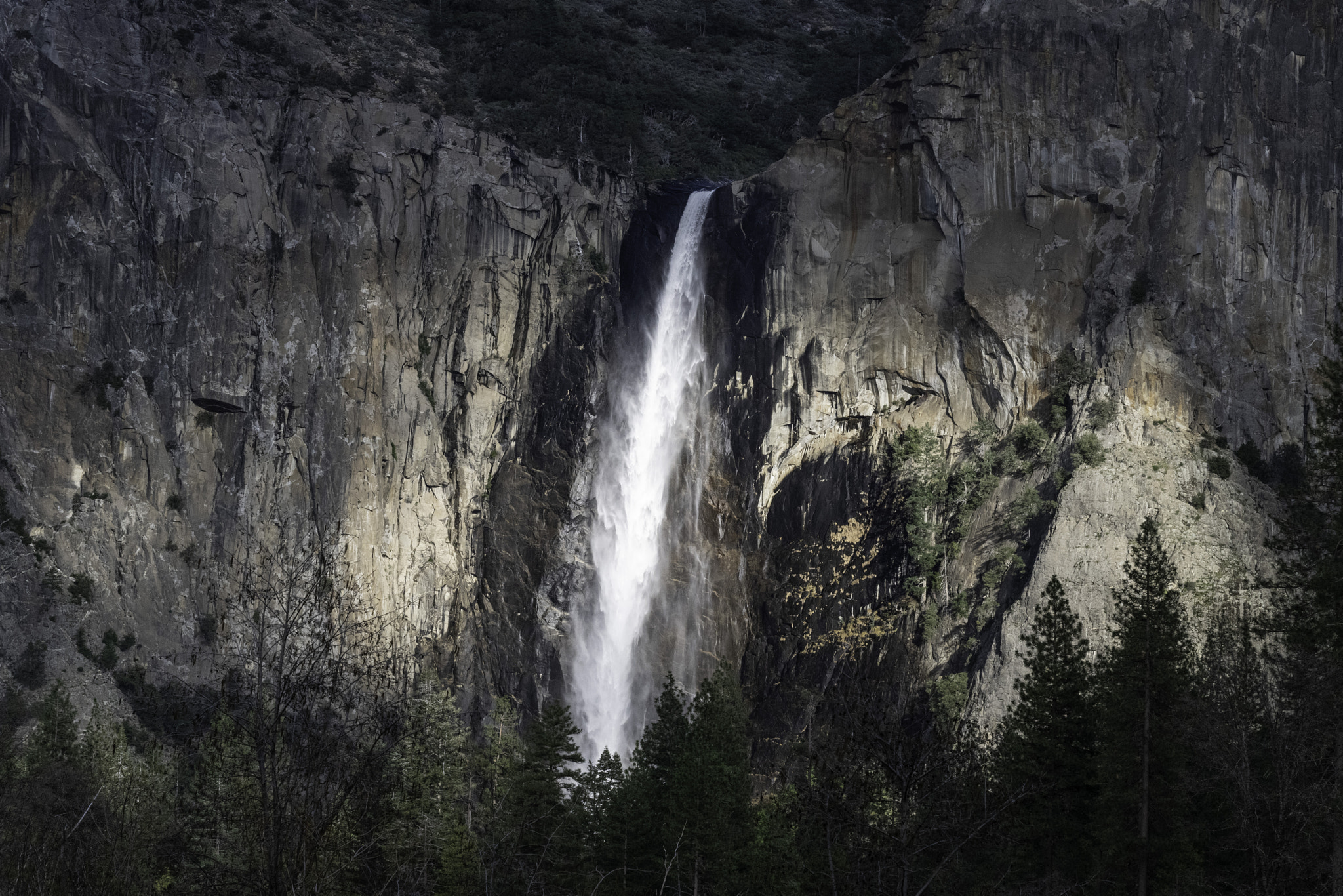 Majestic Waterfall Cascading Down Rocky Cliff Symbolizing Nature's ...