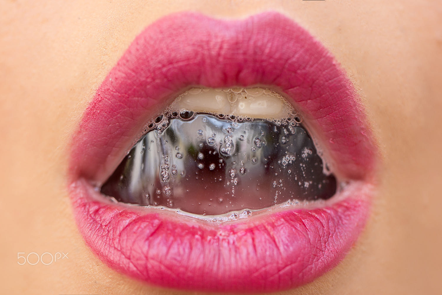 female lips with a bubble of saliva by Volodymyr Tverdokhlib / 500px