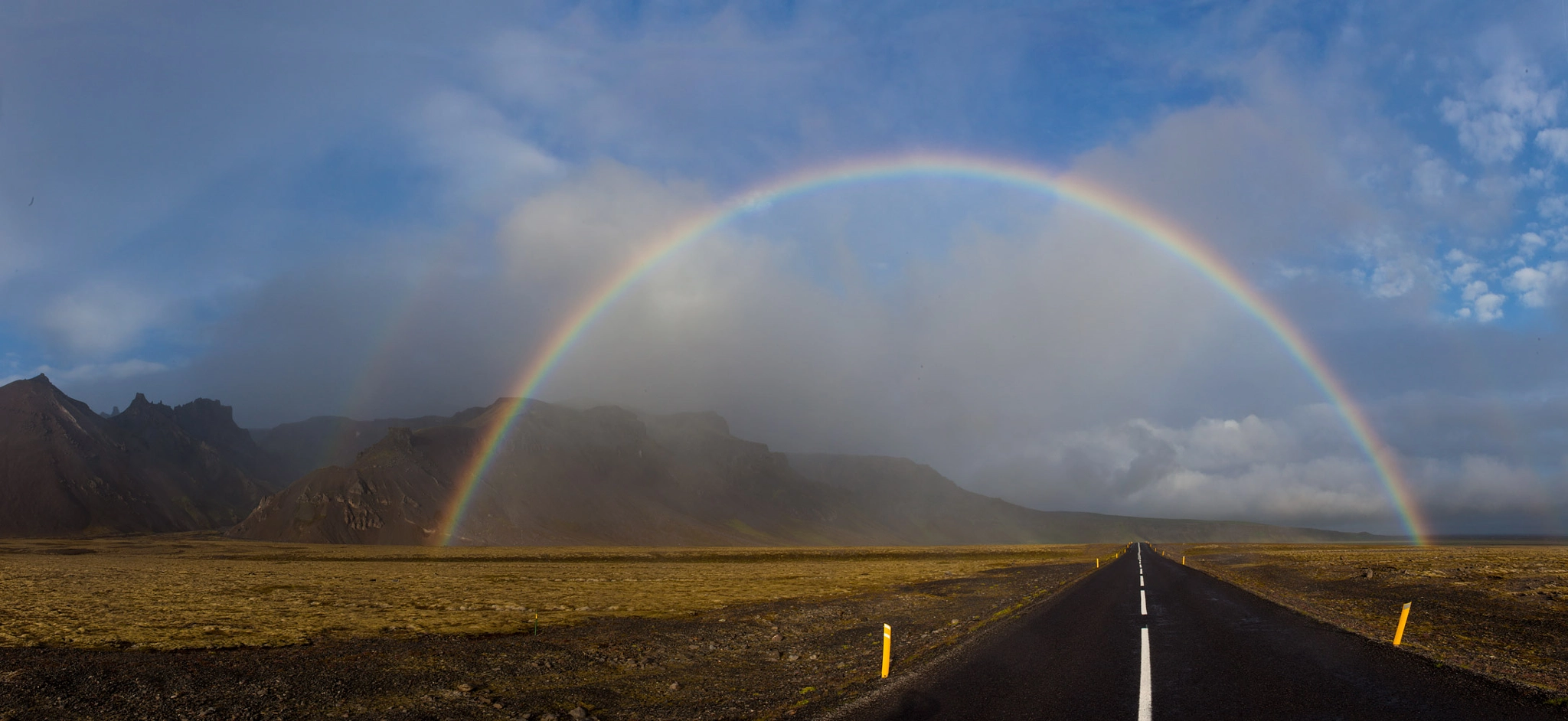 rainbow on a road in iceland by Paul Lackner / 500px