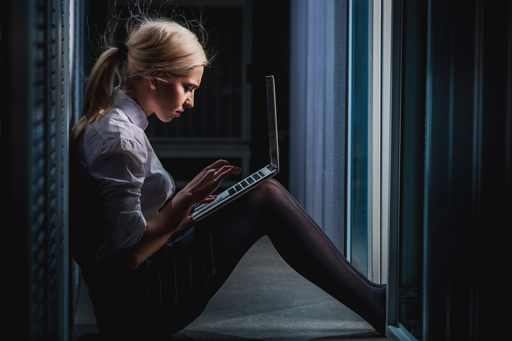 Young engineer businesswoman in server room by Mark Agnor / 500px