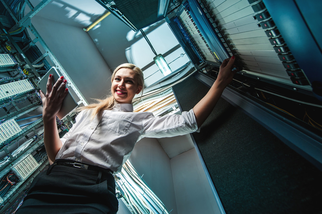 Young engineer businesswoman in server room by Mark Agnor / 500px