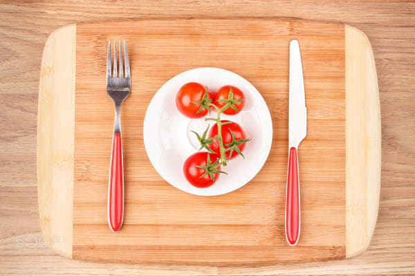 A fresh red tomato on a white plate by Igor Butseroga | 500px