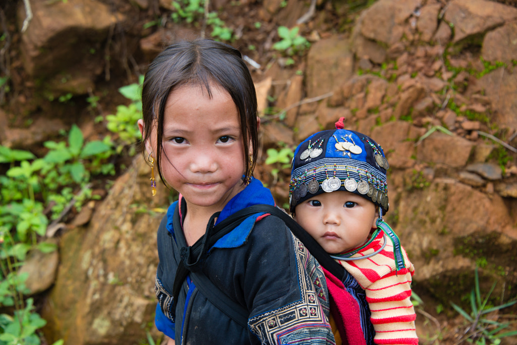 Hmong girl carrying a baby by Nir Tal / 500px