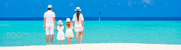 Beautiful tropical beach landscape with family in white enjoying summer ...