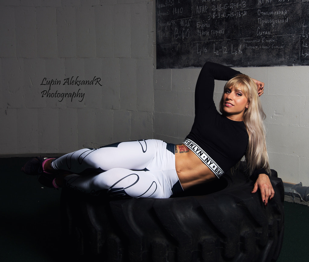 nice fitness model lies on the tires by ALEKSANDER Lupin / 500px
