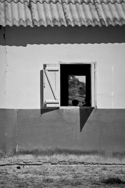 window of an African building with open window and corrugated iron roof ...