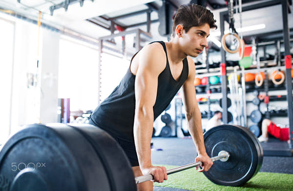 Young fit hispanic man in gym lifting heavy barbell by Jozef Polc | 500px