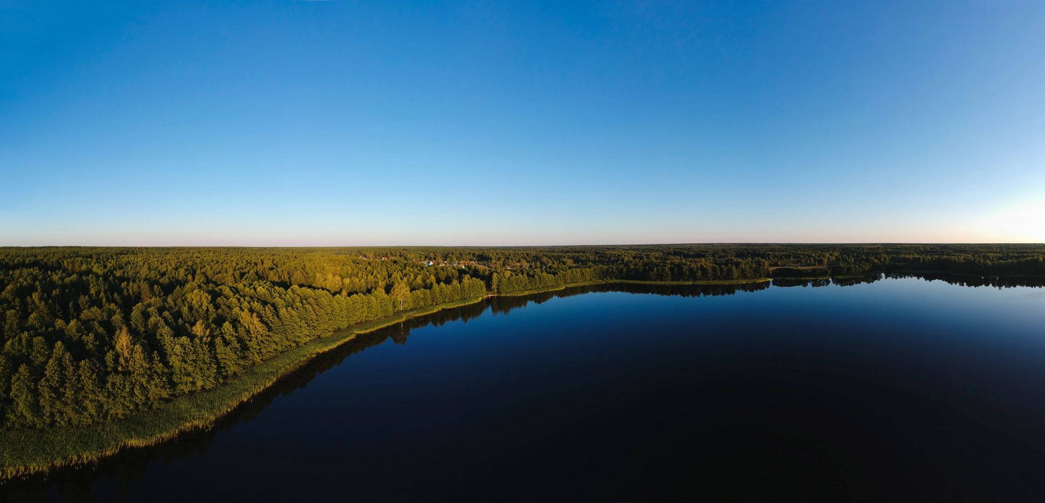 View of the lake near the forest at sunset from a height by Dmitriy Danilov | 500px
