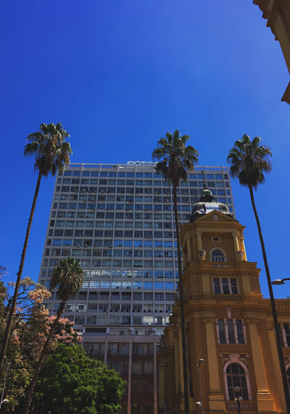 Modern Building and Historic Architecture with Palm Trees Under Blue ...