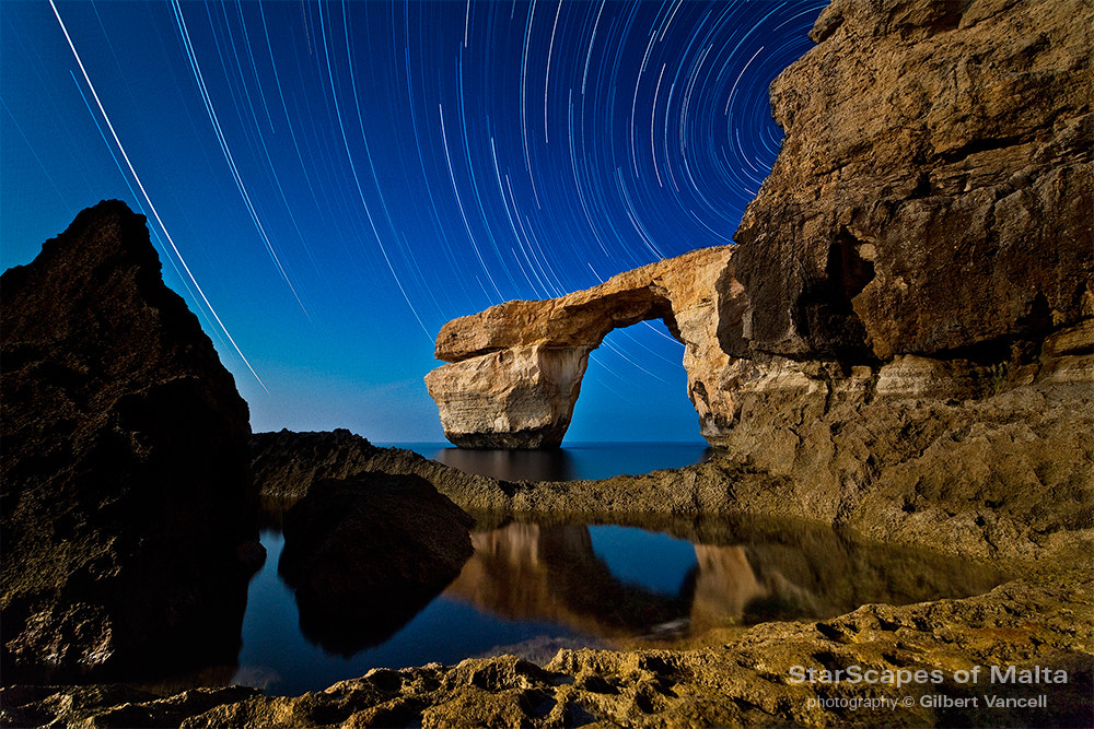 Startrails over the 'Azure Window' natural arch in Dwejra, Limits of ...